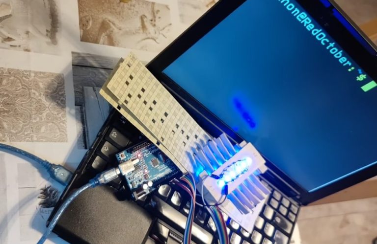 Punch card-controlled computer says 'Let there be light!'